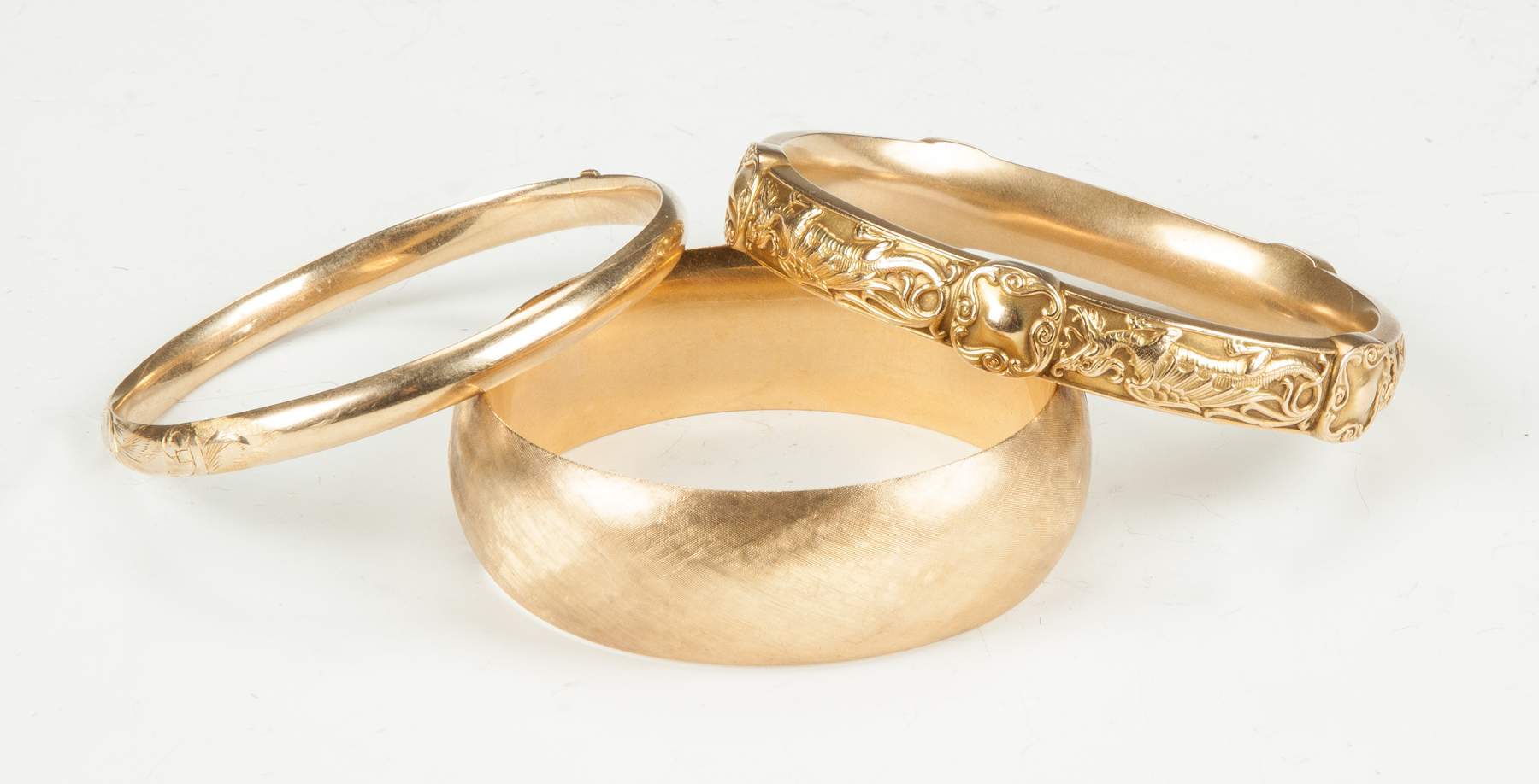 Three Gold Bangle Bracelets | Cottone Auctions